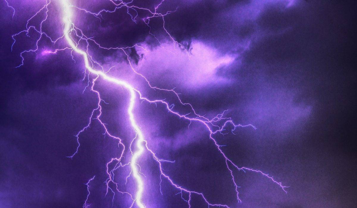 Lightning bolt zigzagging across a dark, stormy sky, illustrating its ...